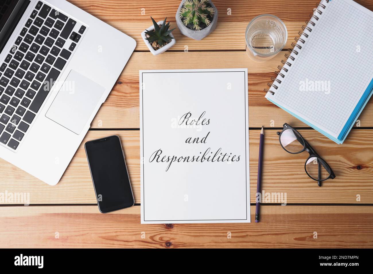 Sheet of paper with text Roles and Responsibilities on wooden ...