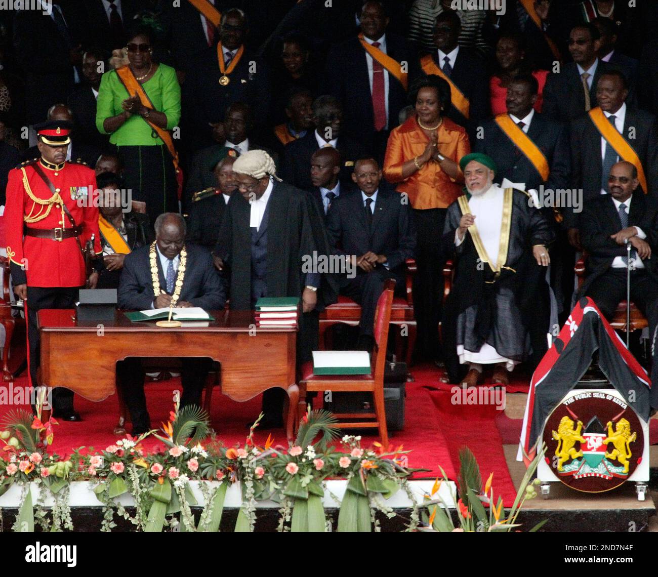 Kenyan President Mwai Kibaki signs the country's new constitution into ...