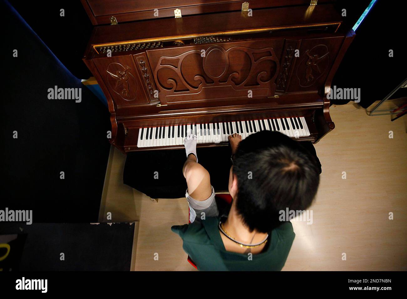 In this Aug. 26, 2010 photo, pianist Liu Wei plays the piano with his ...