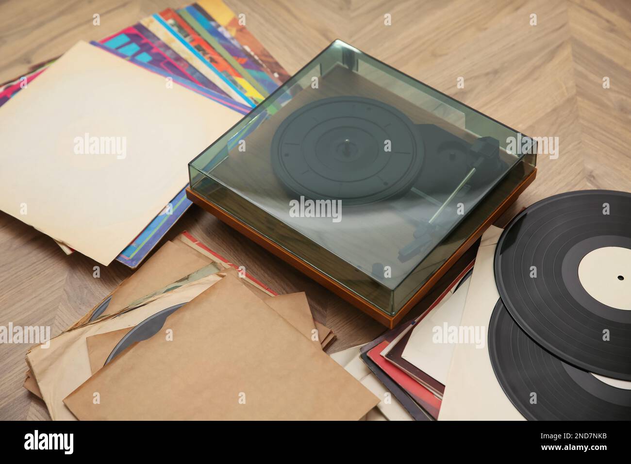 Stylish turntable with vinyl records on floor Stock Photo - Alamy