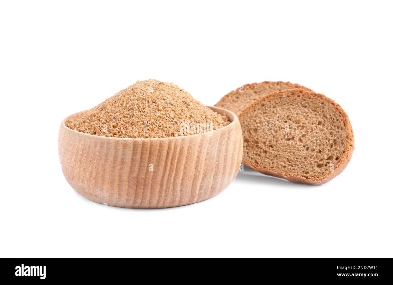 Fresh bread crumbs in bowl and slices of loaf on white background Stock ...