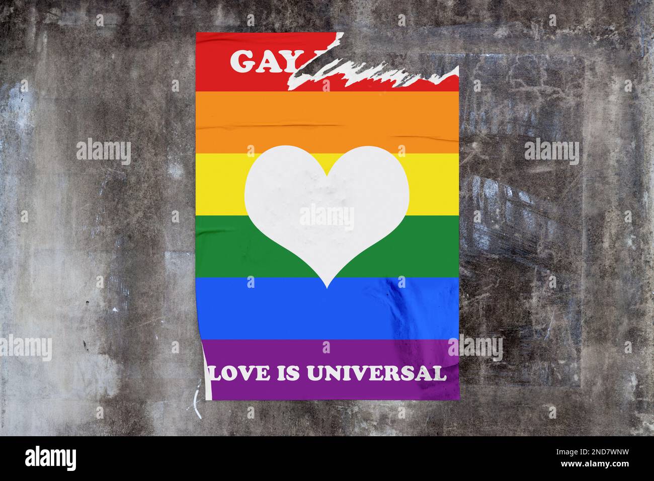Full-frame weathered concrete wall with a torn rainbow poster in the ...