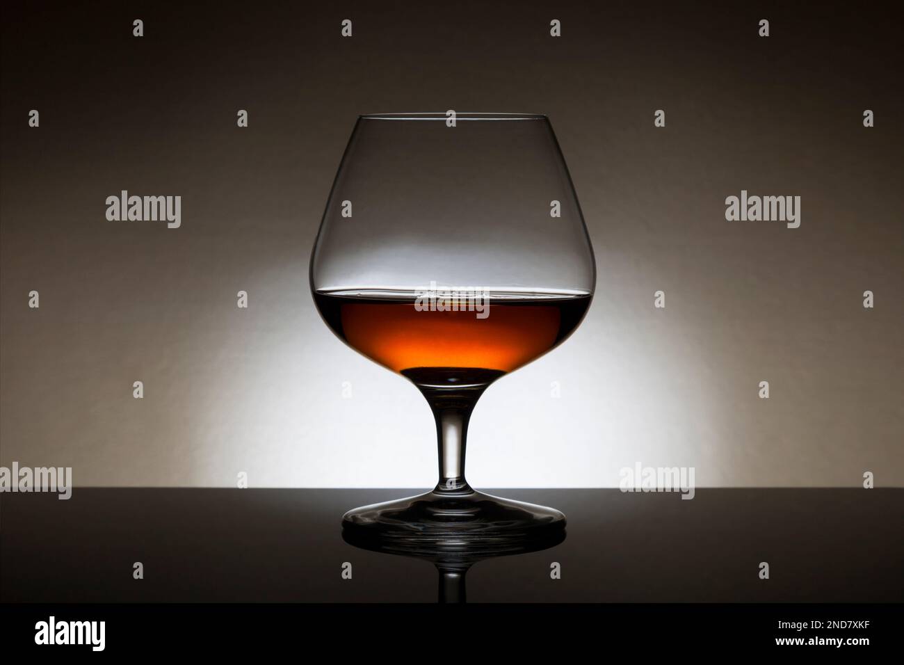Cognac in a backlit glass Stock Photo - Alamy