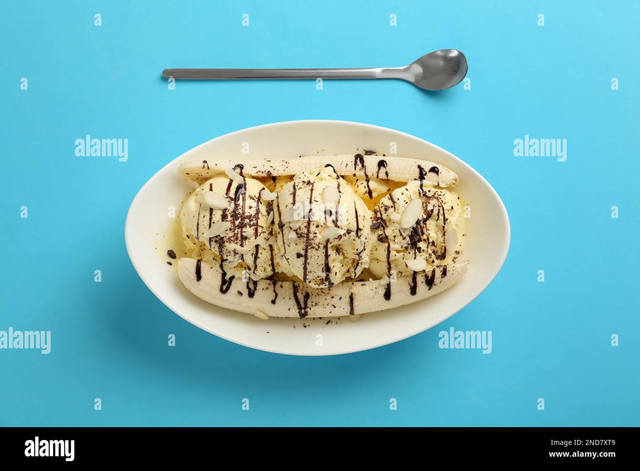 Delicious banana split ice cream with toppings on light blue background ...