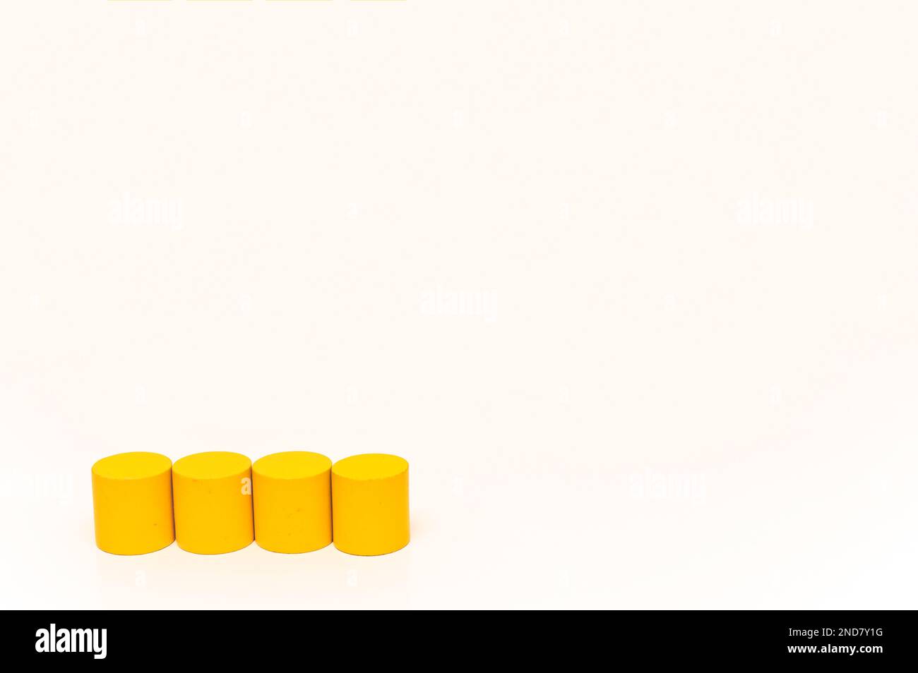 Yellow cylinder shapes of the same size. copy space Stock Photo - Alamy