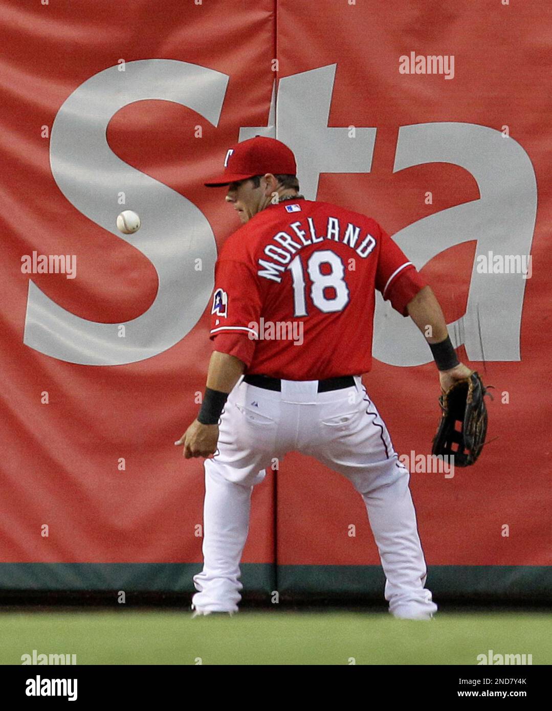 Texas Rangers right fielder Mitch Moreland looks at the ball as it ...