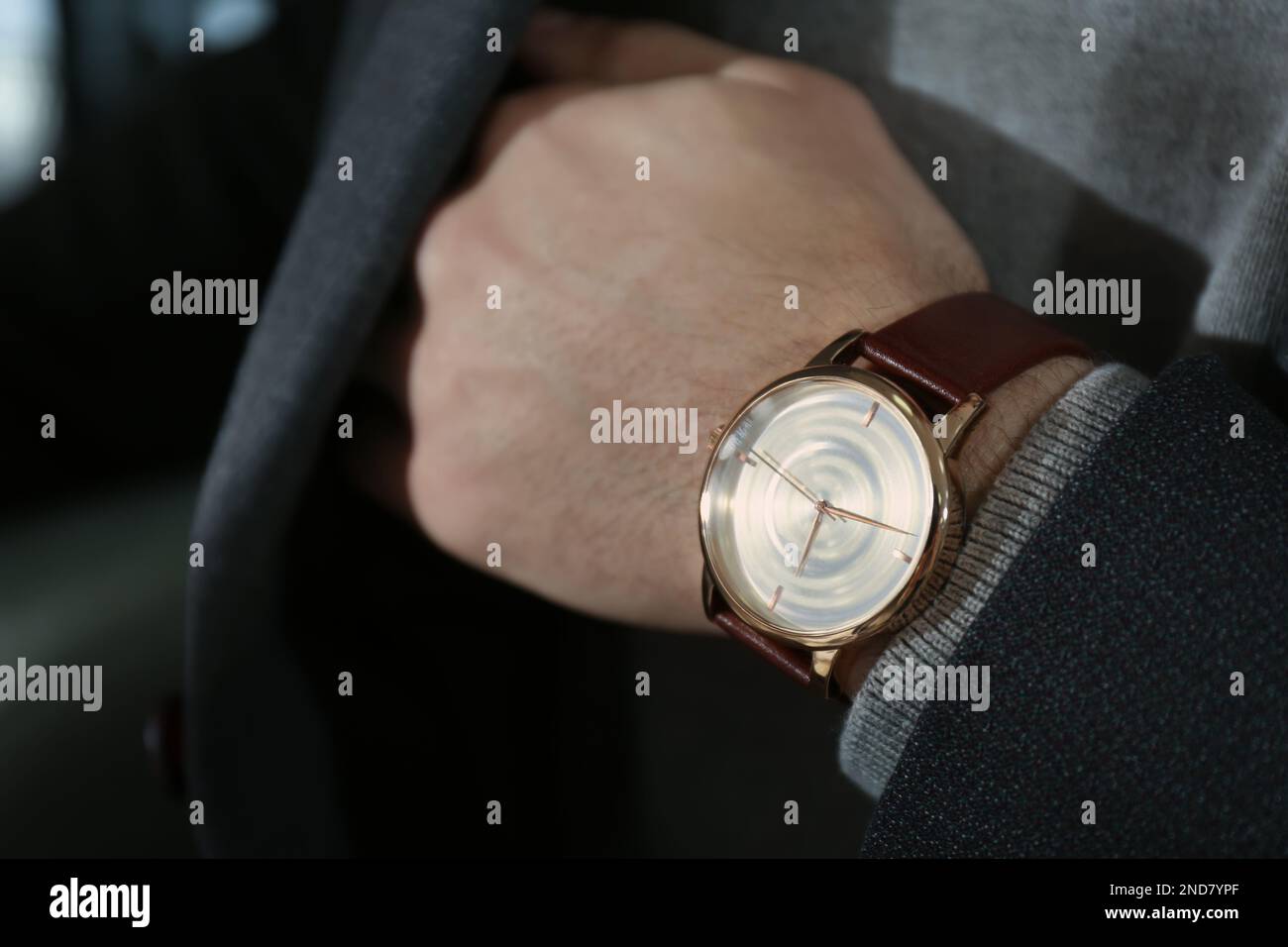 Man wearing luxury wrist watch with leather band, closeup Stock Photo ...