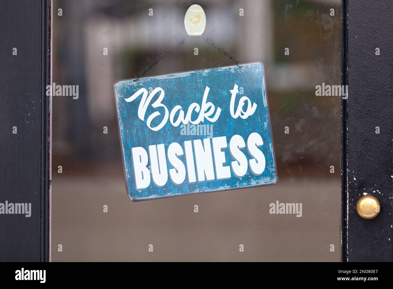Blue closed sign with written in it "Back to business Stock Photo - Alamy