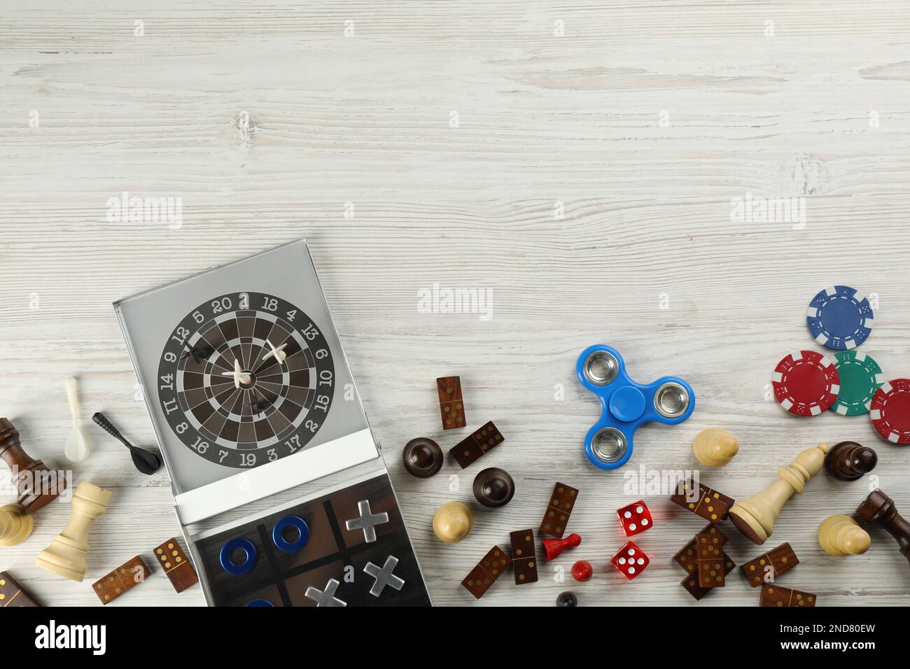 Elements of different board games on white wooden table, flat lay ...