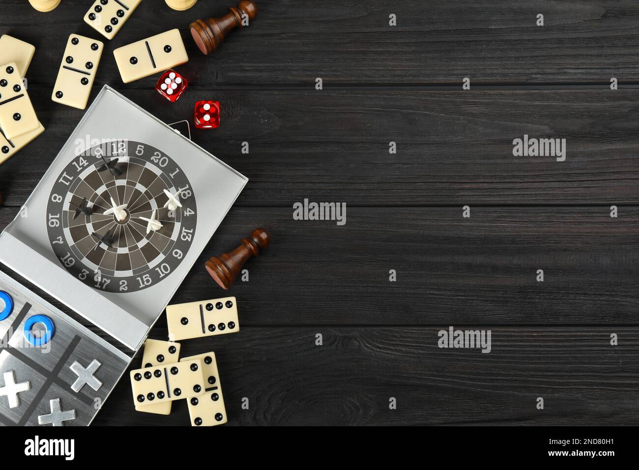 Elements of different board games on dark wooden table, flat lay. Space ...