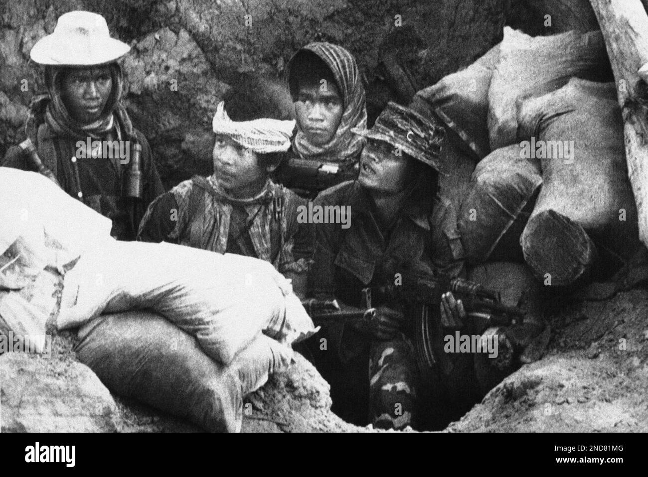 Guerrillas of the Khmer People’s National Liberation Front sit in a ...