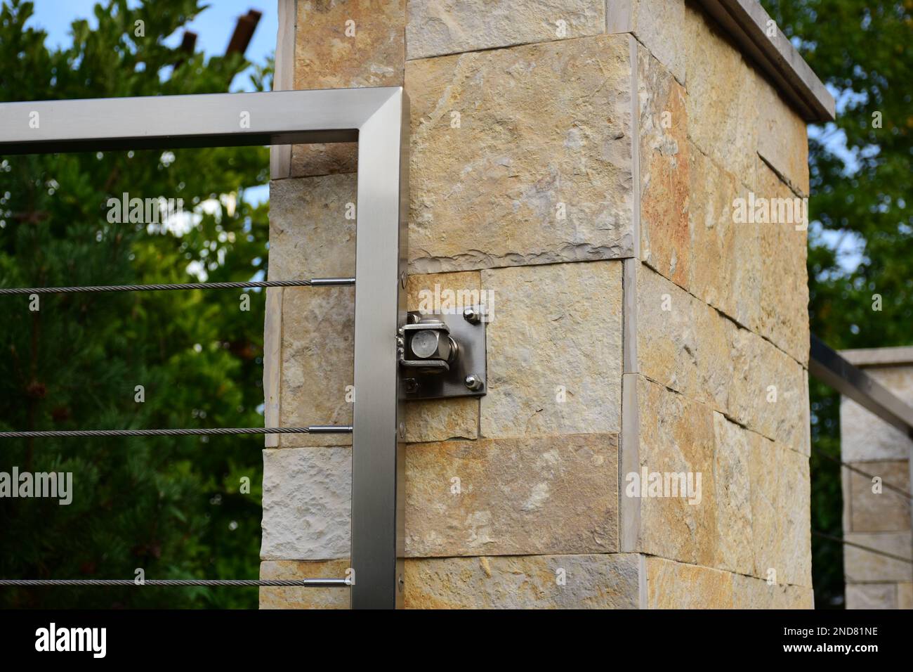 textured beige natural stone fence post or pier with stainless steel ...