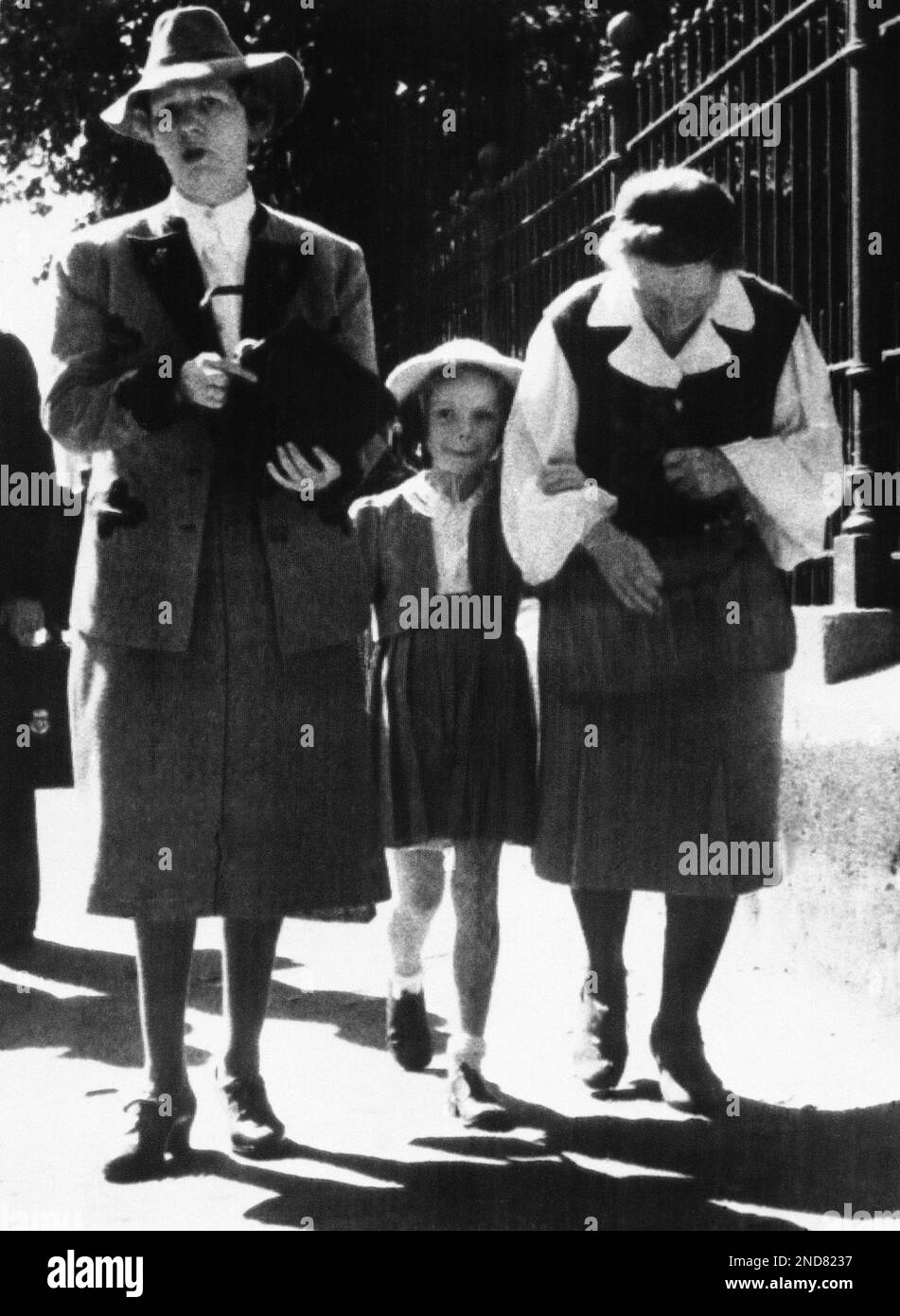Emmy Goering, left, and her daughter Etta, center, accompanied by an ...