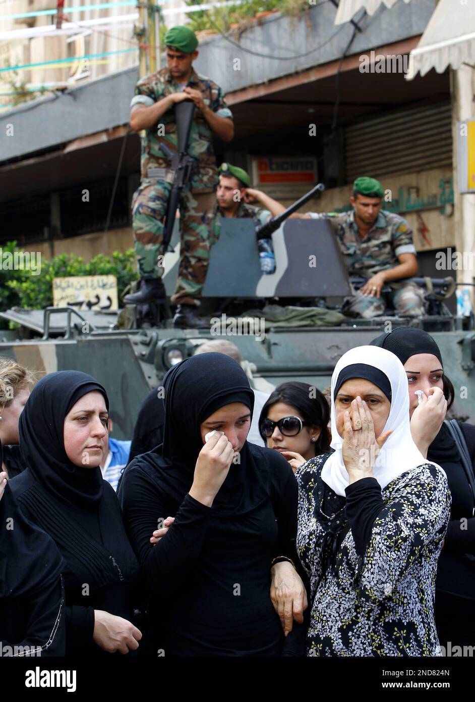 The sister of Ahmad Jamal Omeirat, center, a member of the Sunni ...