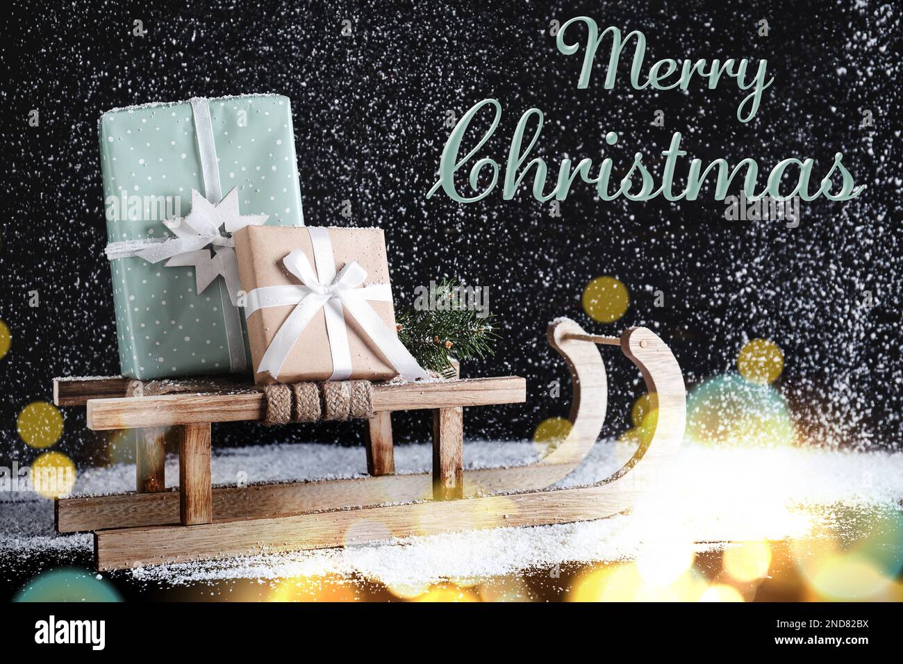 Merry Christmas. Sleigh with gift boxes under snowfall Stock Photo - Alamy