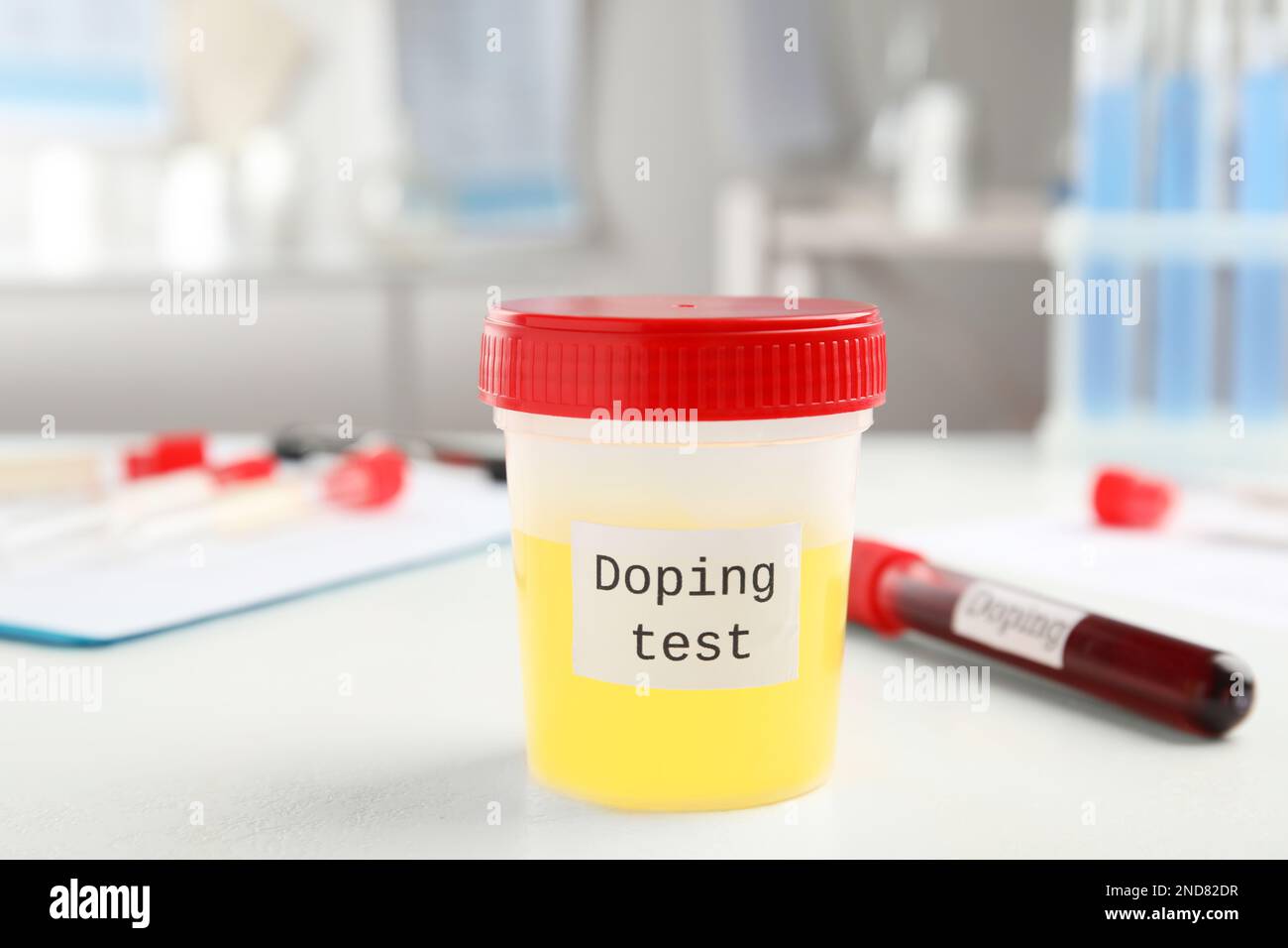 Jar with urine sample on white table indoors. Doping control Stock ...