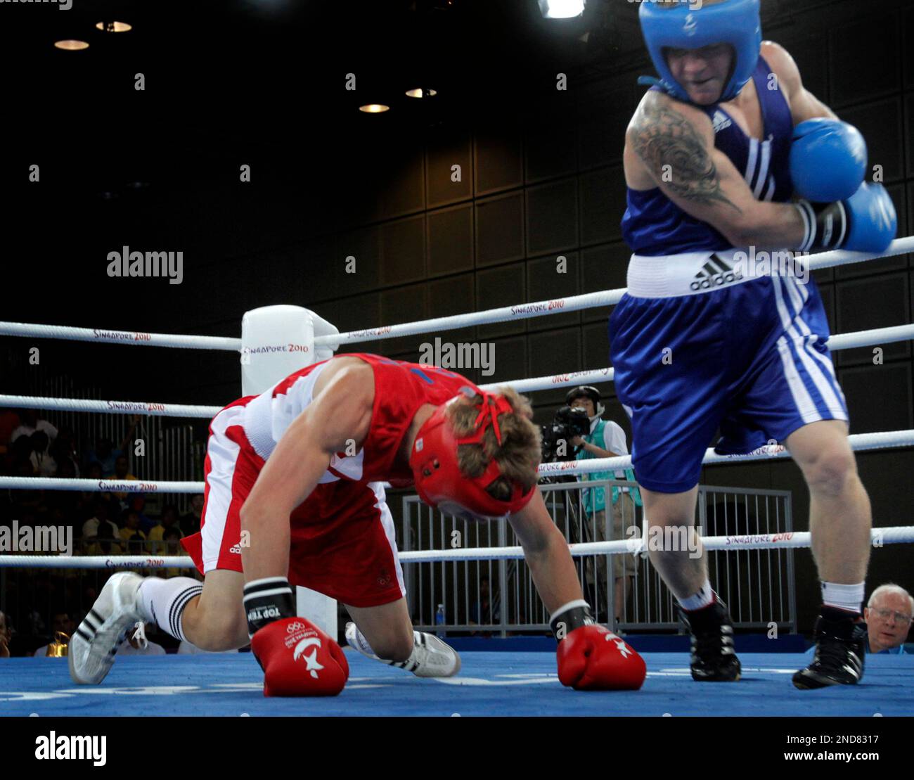 Brett Mather of Australia lies on the canvas as Evaldas Petrauskas of ...