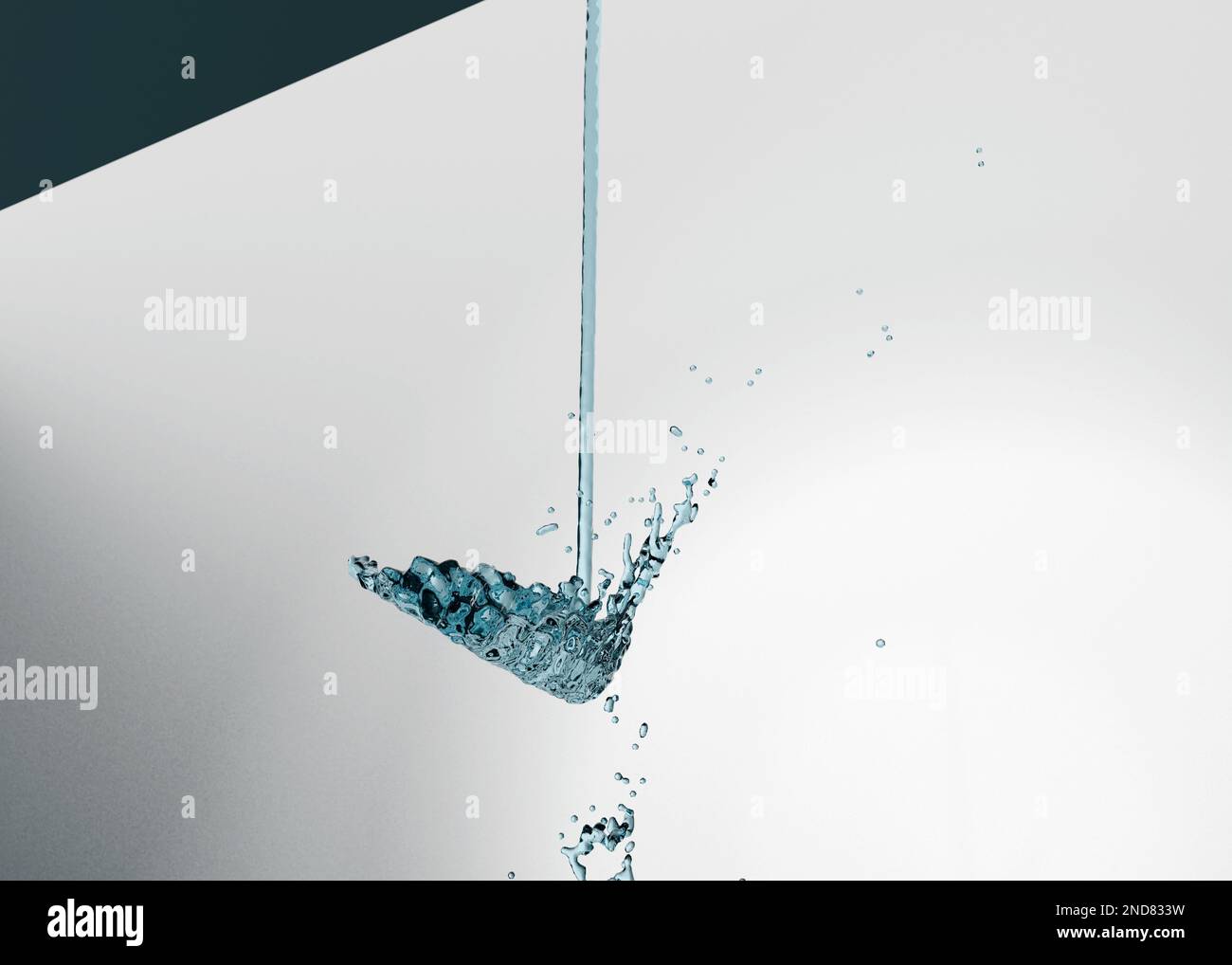 A pitcher splashing out of an empty glass with some water, bright ...