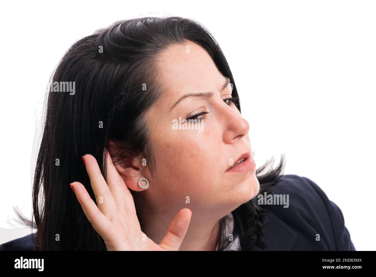 Close-up of curious adult businesswoman touching ear with index finger ...