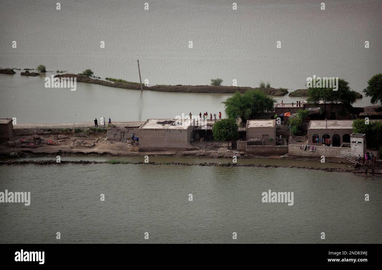 n this picture taken Tuesday, Aug. 24, 2010, Pakistani residents stand ...
