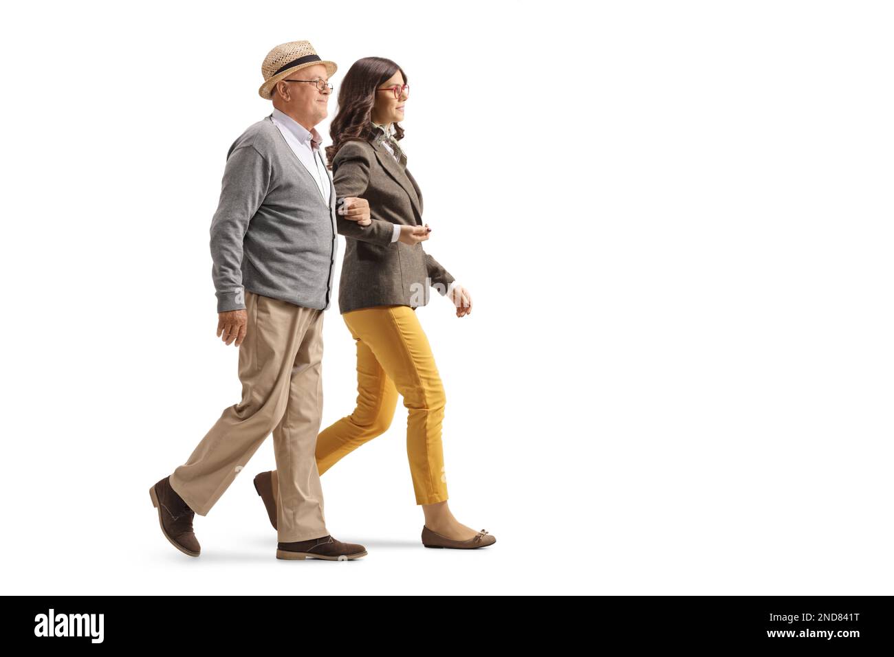 Elderly man holding a young woman under arm and walking together ...