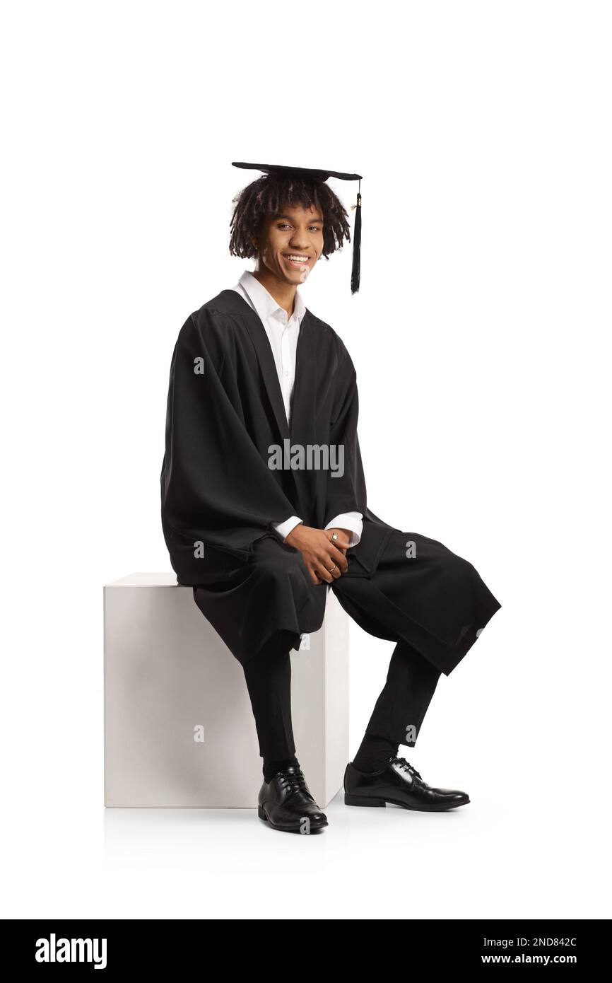 Male african american graduate student in a gown sitting and smiling ...