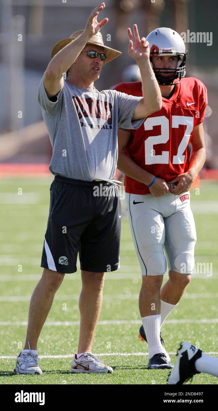 UNLV football coach Bobby Hauck, left, works with kicker Nolan Kohorst ...