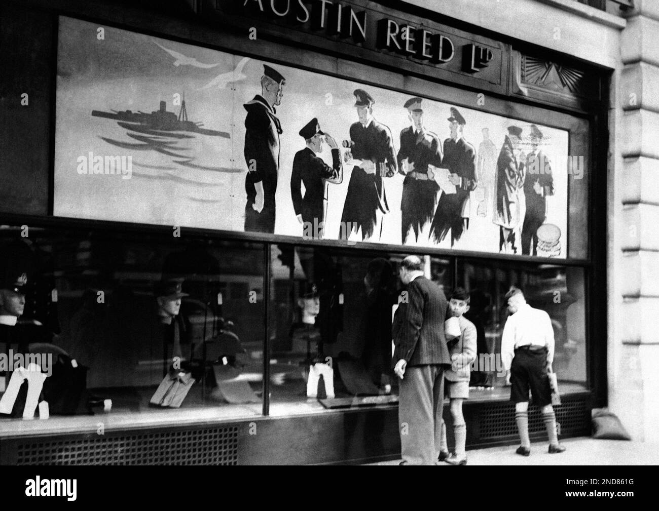 A decorative panel replacing part of the glass front of a shop window ...