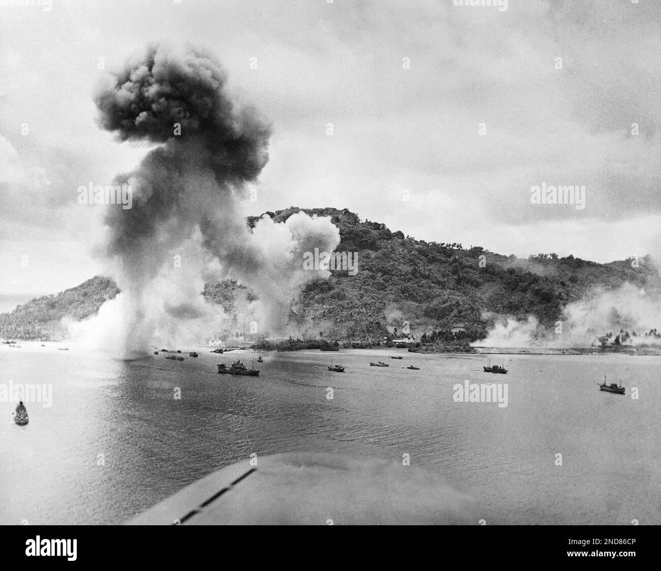 Smoke rises from the harbor installations at the Japanese naval base on ...