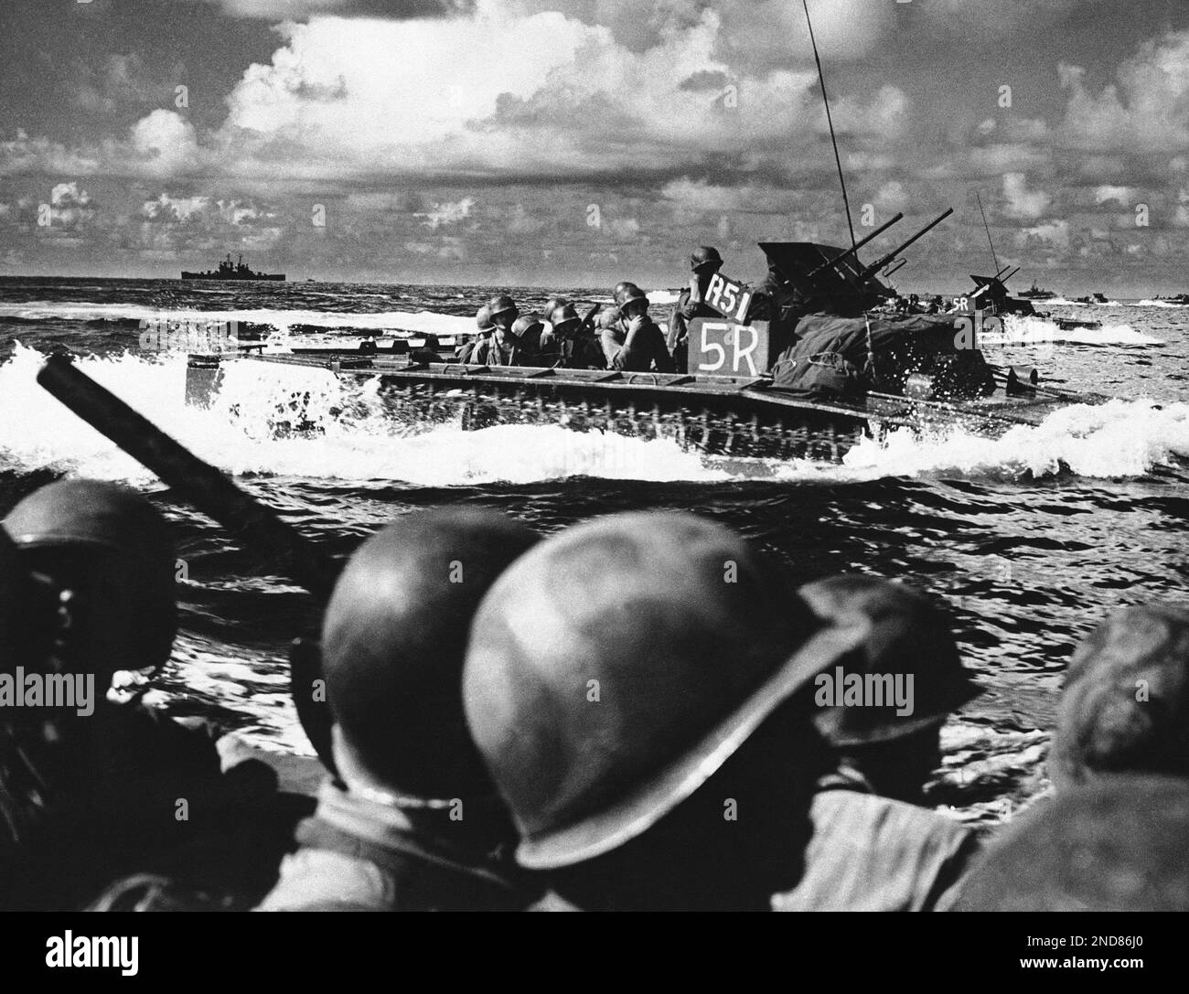Guns readied, grim-faced Army infantrymen sweep toward the beach of ...