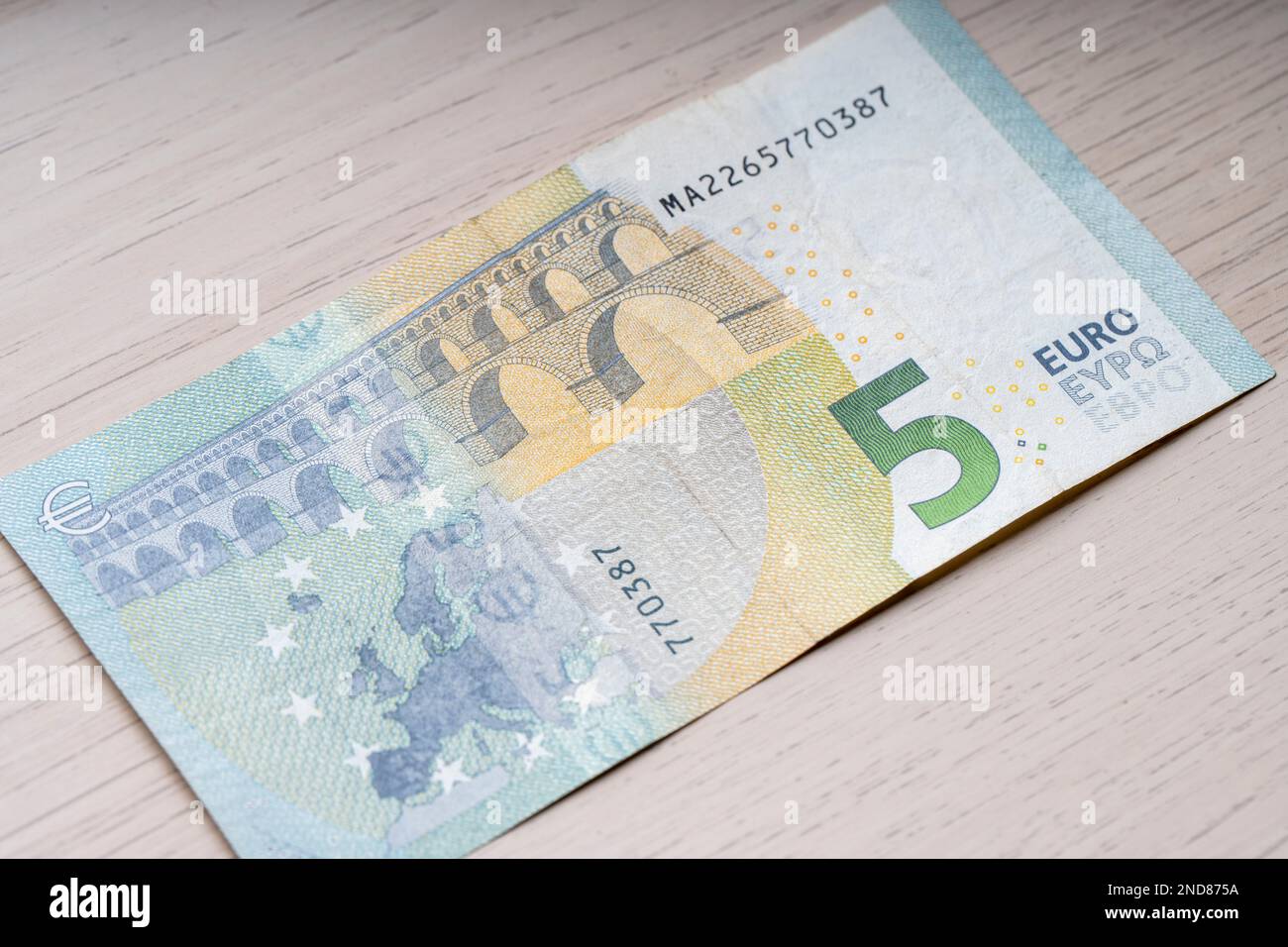5 euro banknote close up, wooden table background for business finance ...
