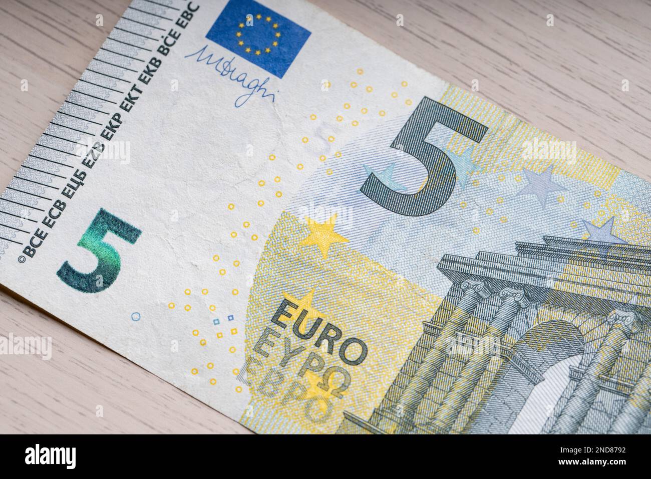 5 euro banknote close up, wooden table background for business finance ...