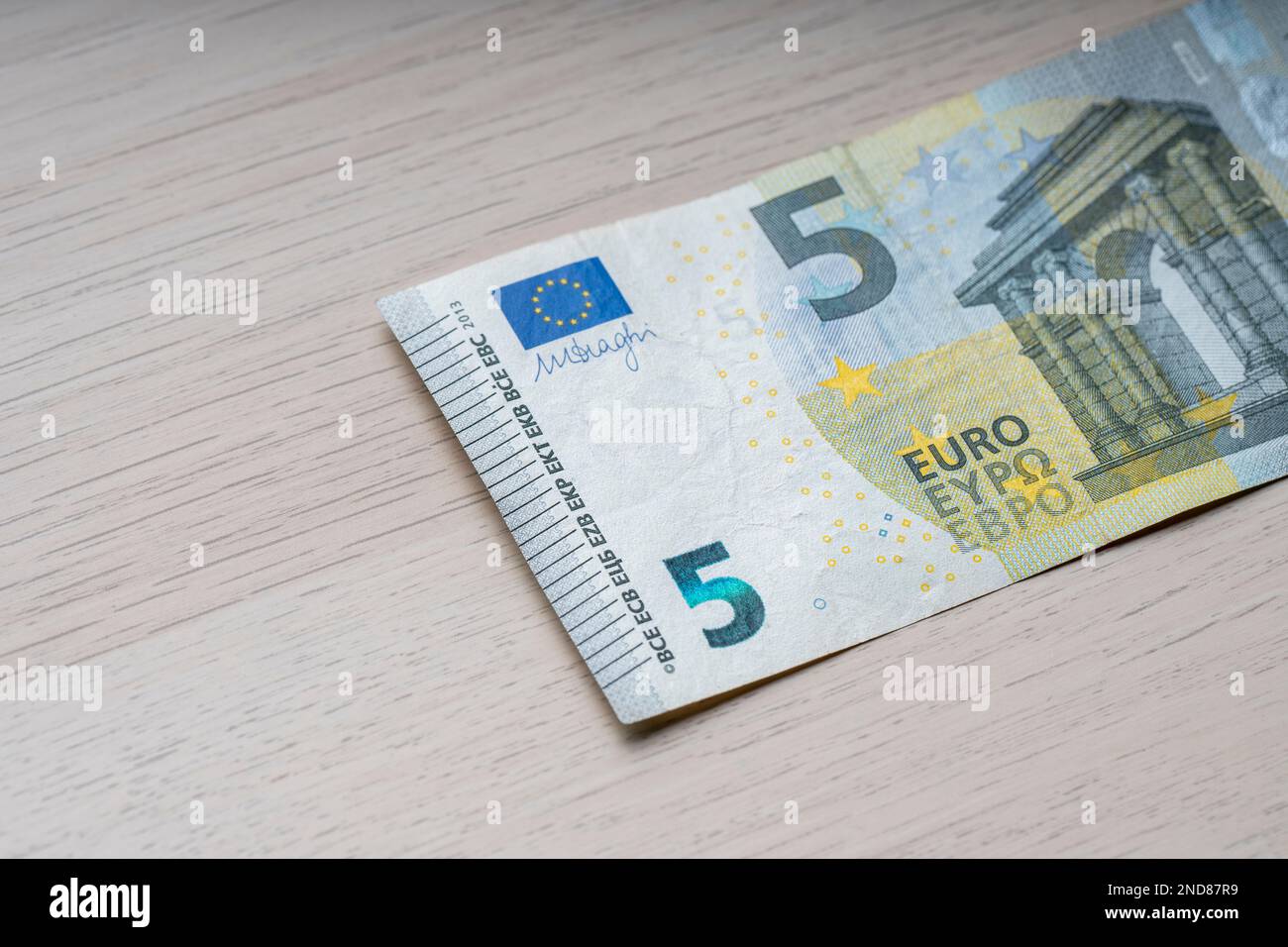 5 euro banknote close up, wooden table background for business finance ...