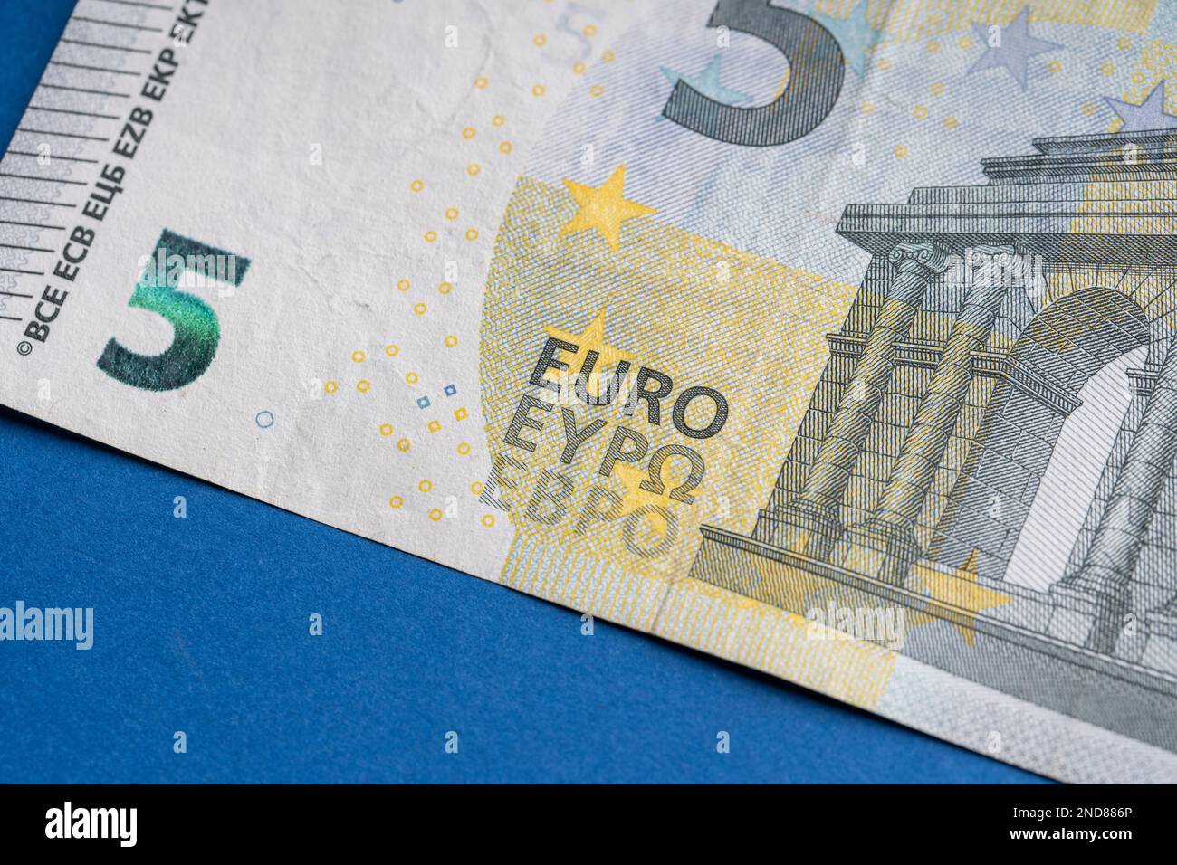 5 euro banknote close up, blue background for business finance topics ...