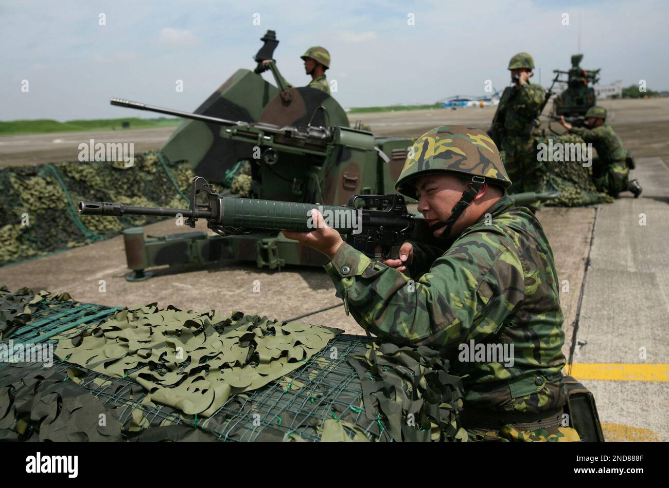 A Taiwan air force soldier takes a guard position in front of an anti ...