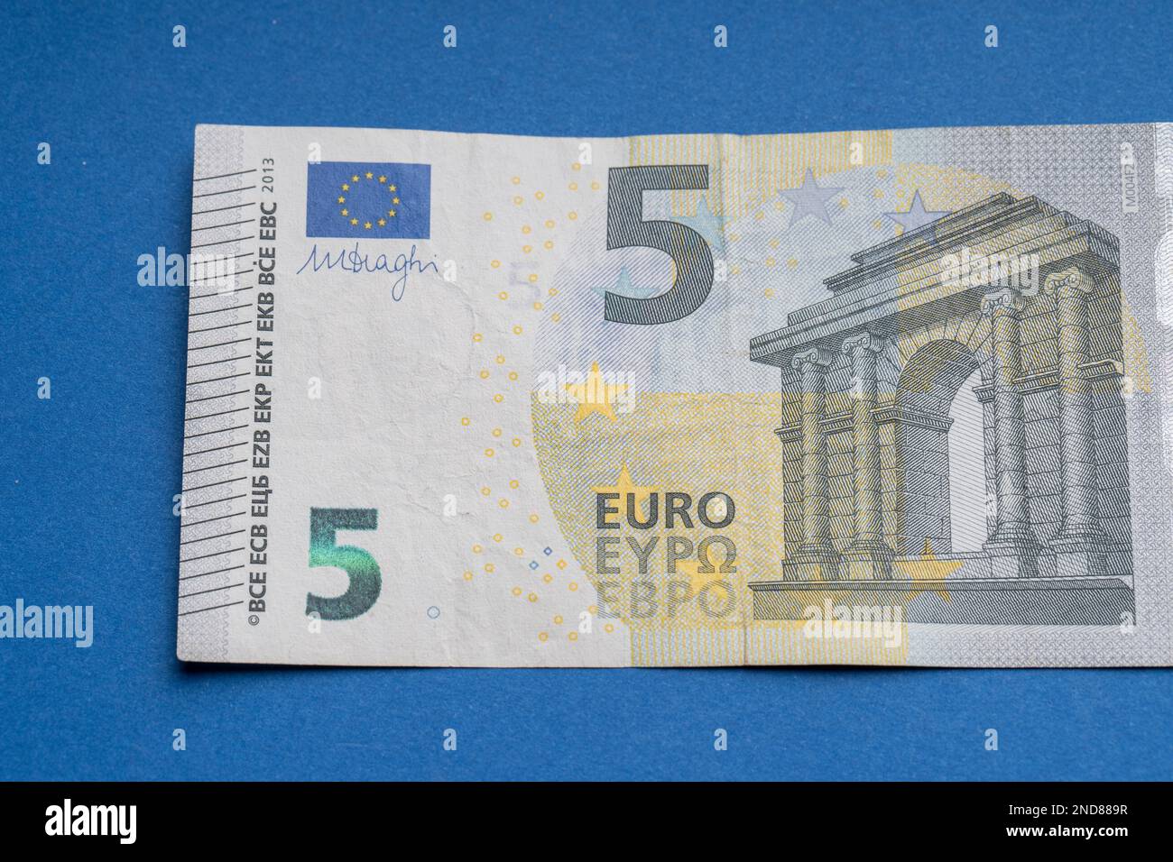 5 euro banknote close up, blue background for business finance topics ...