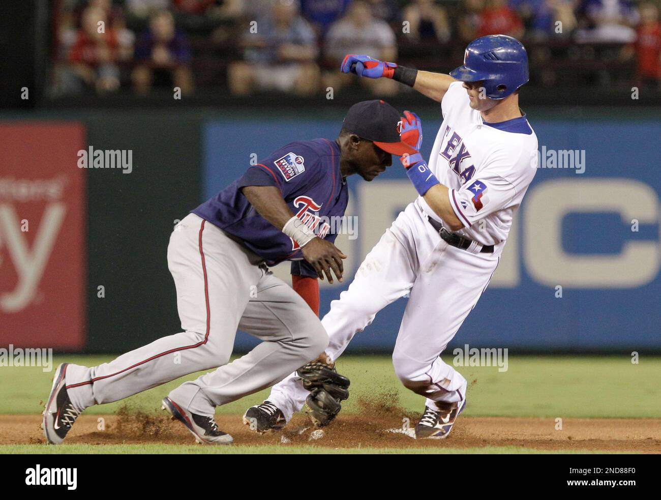 Texas Rangers Michael Young, right, beats the tag of Minnesota Twins ...