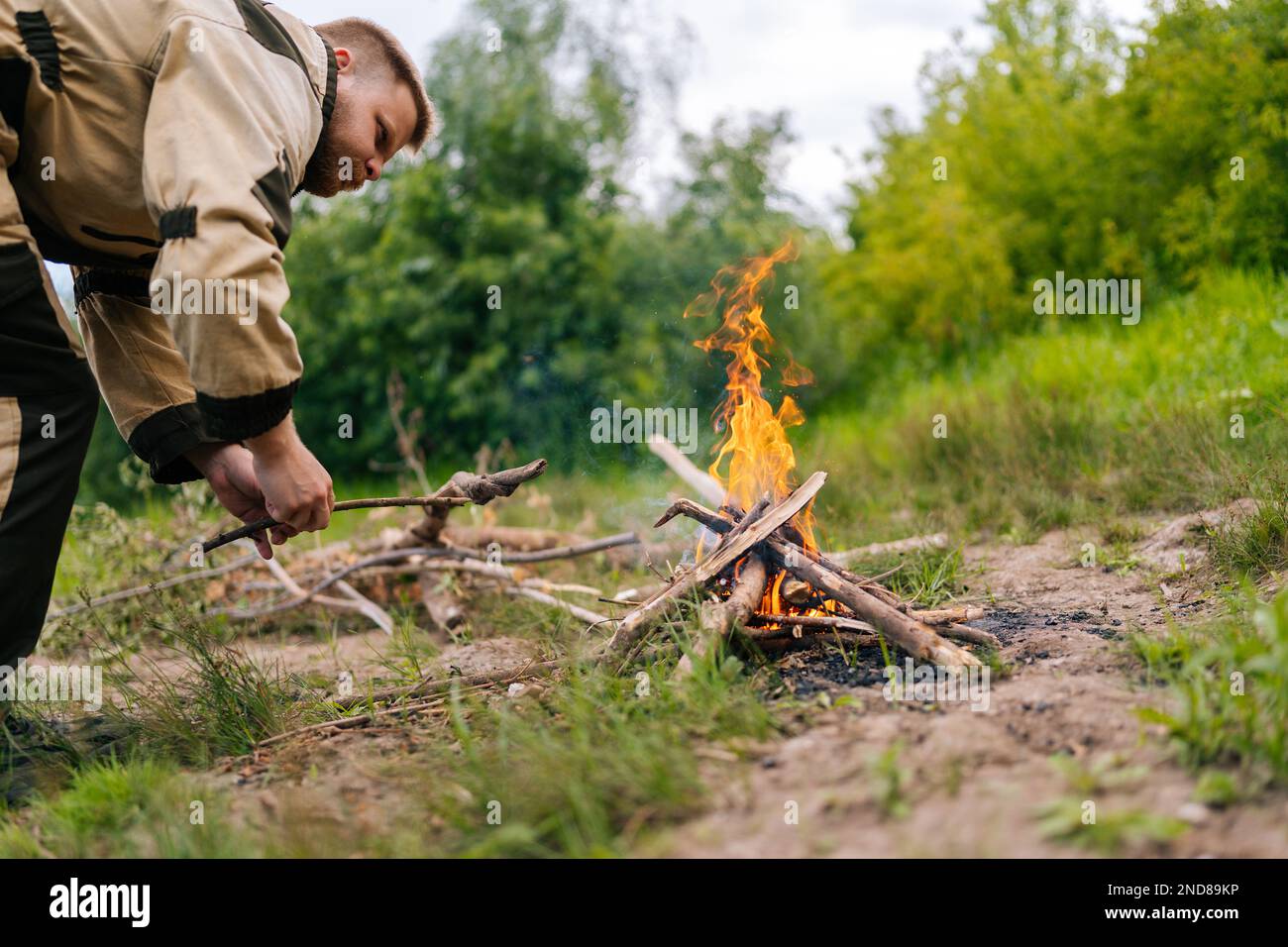 Putting wood on fire outdoors hi-res stock photography and images - Alamy