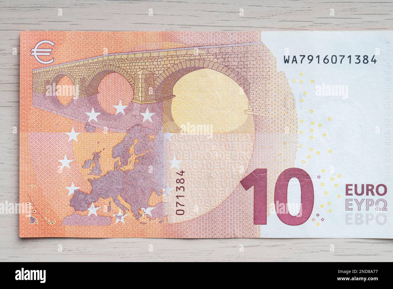 10 euro banknote close up, wooden table background for business finance ...