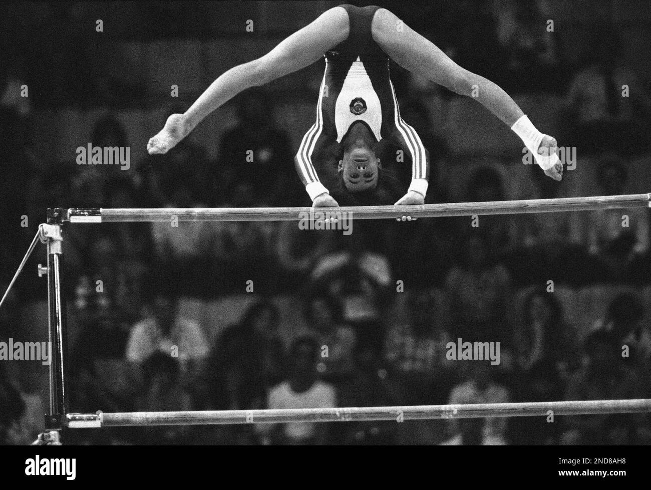 Natalia Shaposhnikova goes over top of uneven bars during her ...