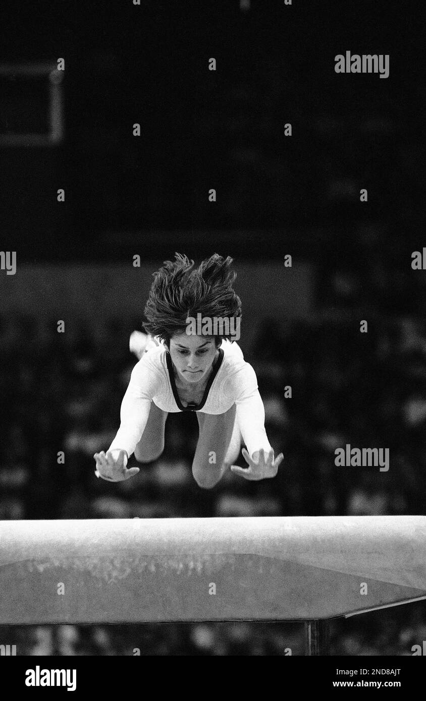 Romanian gymnast Nadia Comaneci flies through the air towards the vault ...