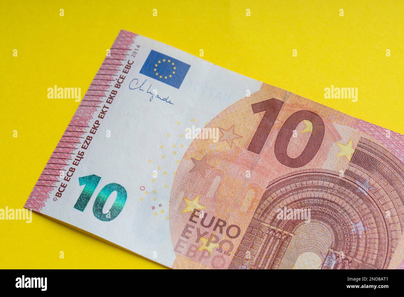 10 euro banknote close up, yellow background for business finance ...