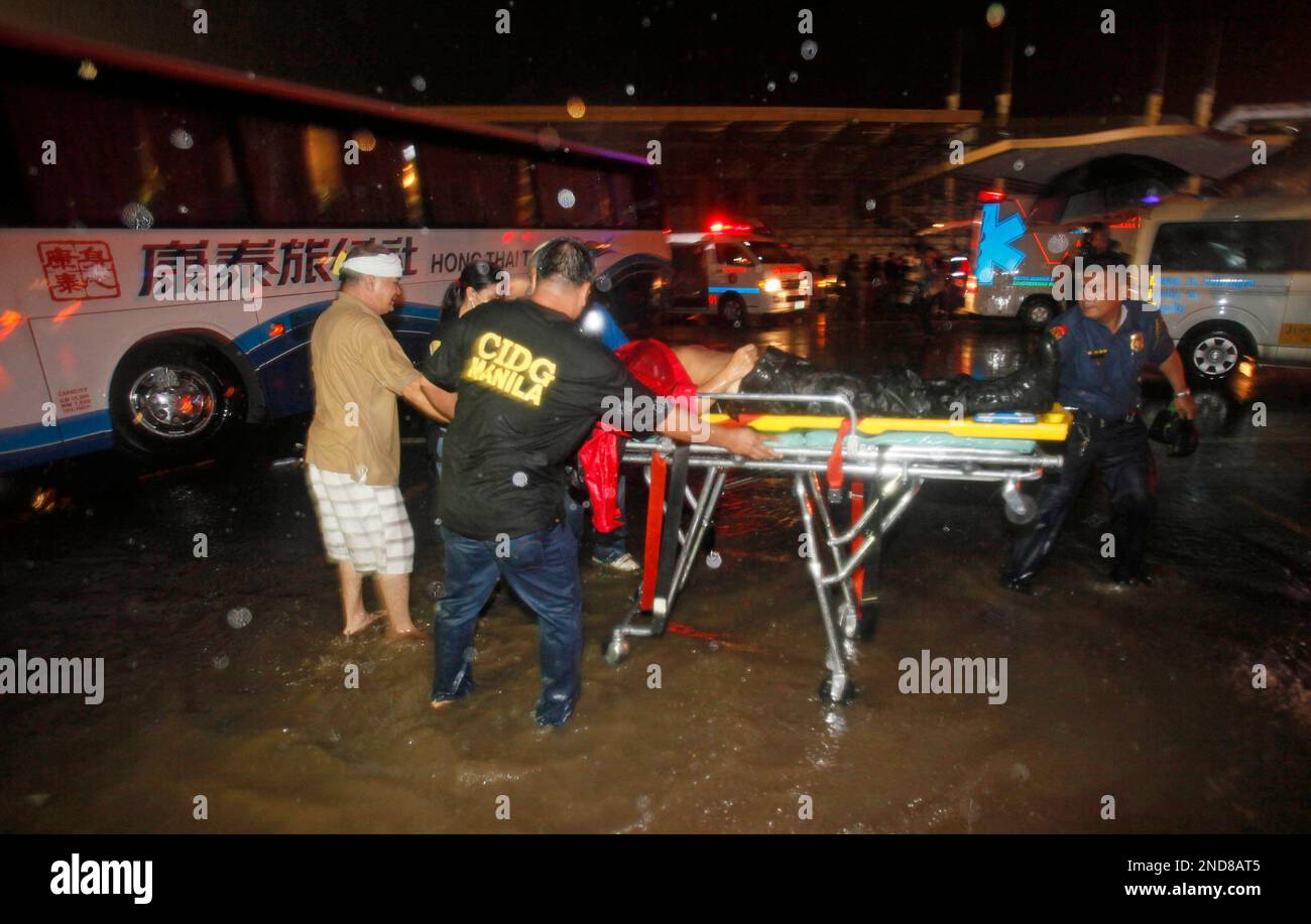 Rescue units wheel a body wearing combat boots following an assault by ...
