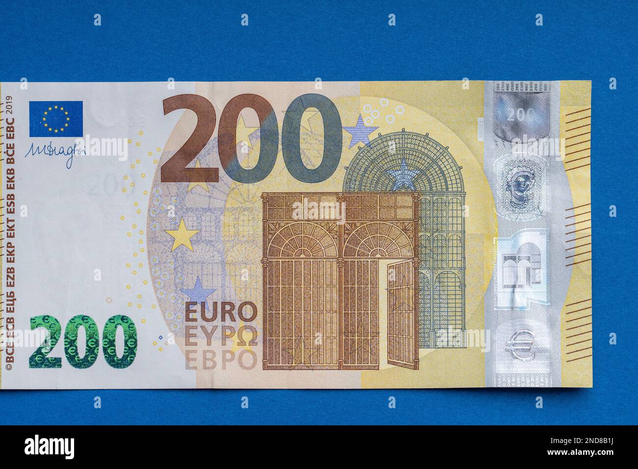 200 euro banknote close up, blue background for business finance topics ...