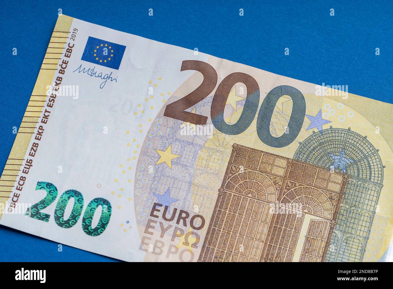 200 euro banknote close up, blue background for business finance topics ...