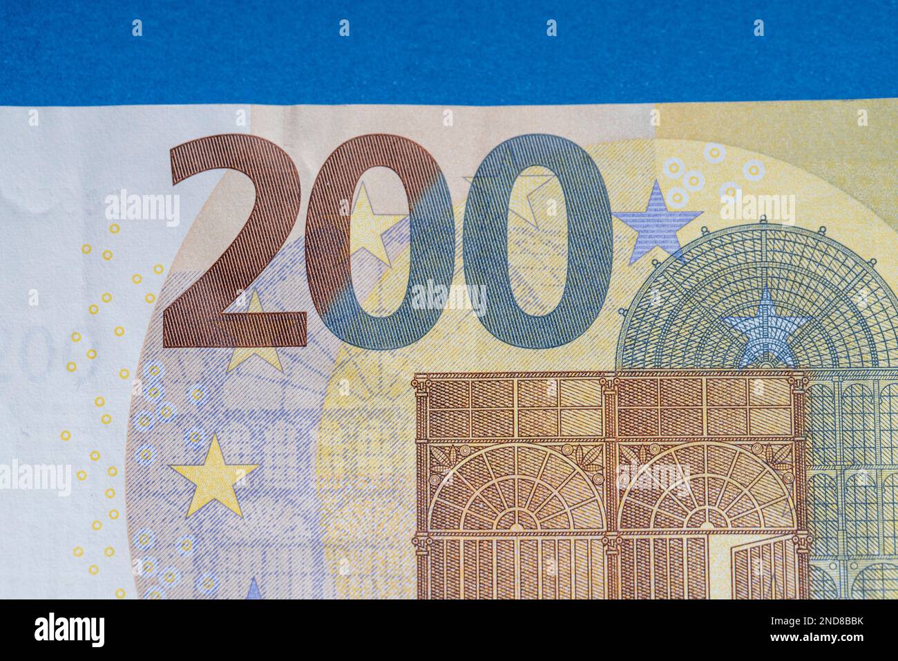 200 euro banknote close up, blue background for business finance topics ...