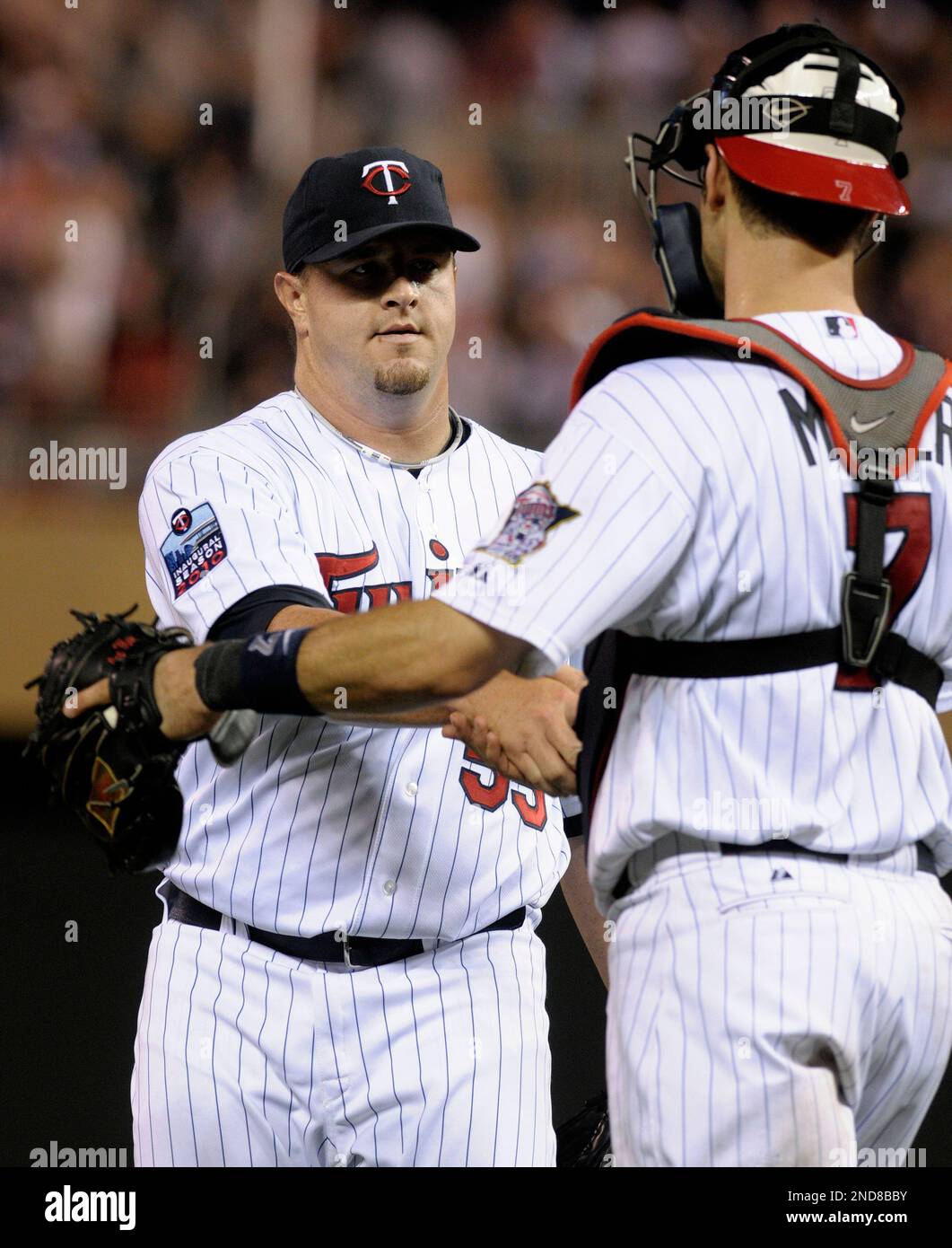 Minnesota Twins catcher Joe Mauer, right, congratulates Twins pitcher ...