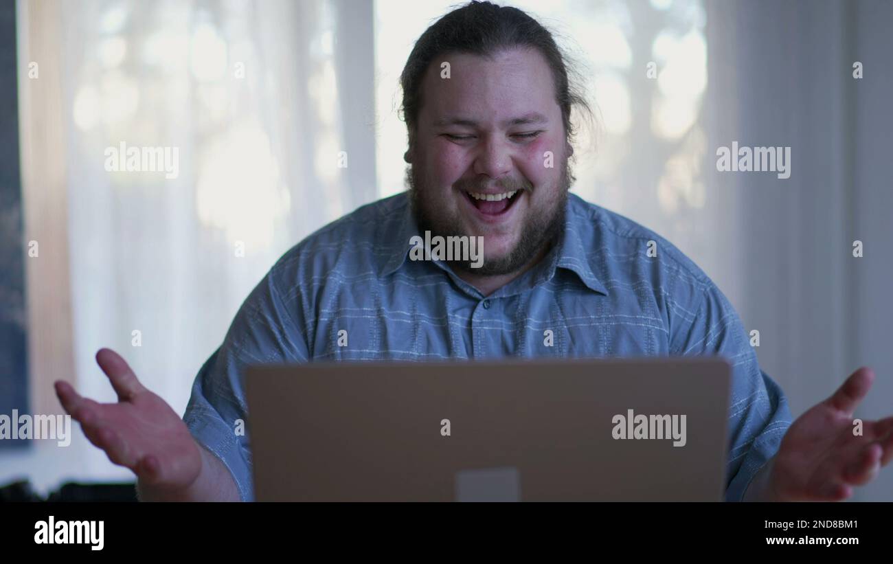 One excited fat man celebrates success in front of computer. close up ...