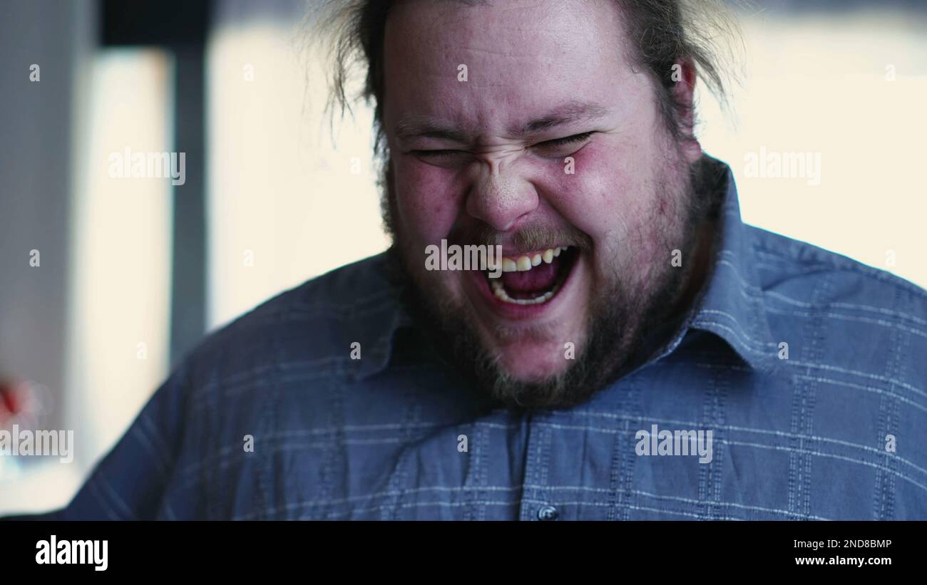 One excited fat man celebrates success in front of computer. close up ...