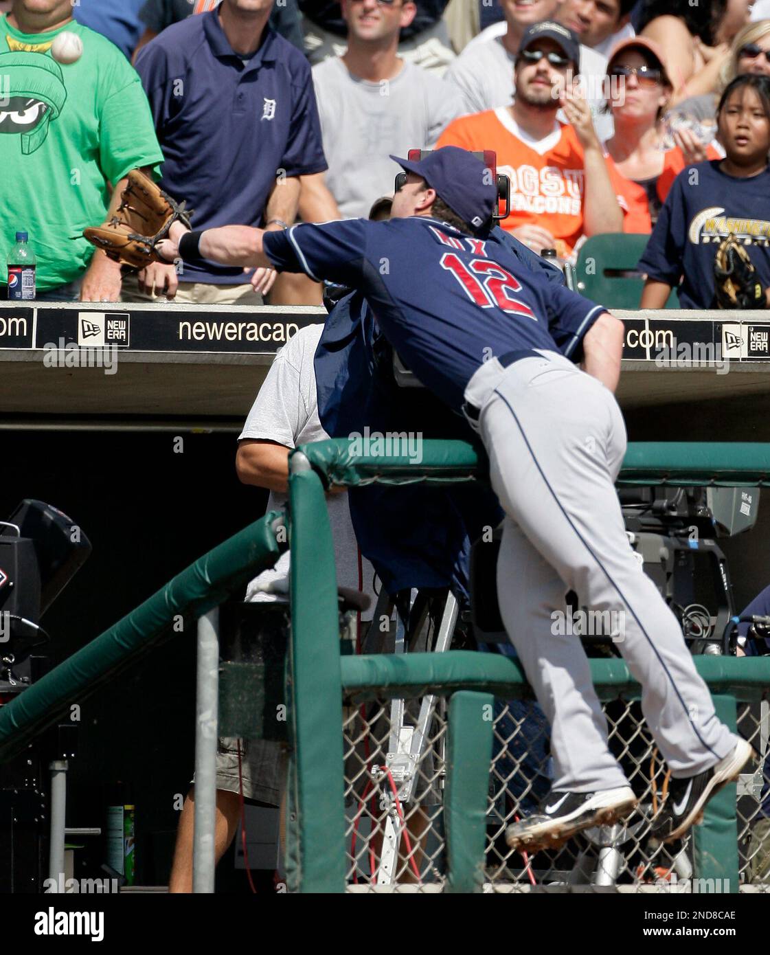 Cleveland Indians third baseman Jayson Nix goes over the dugout rail to ...